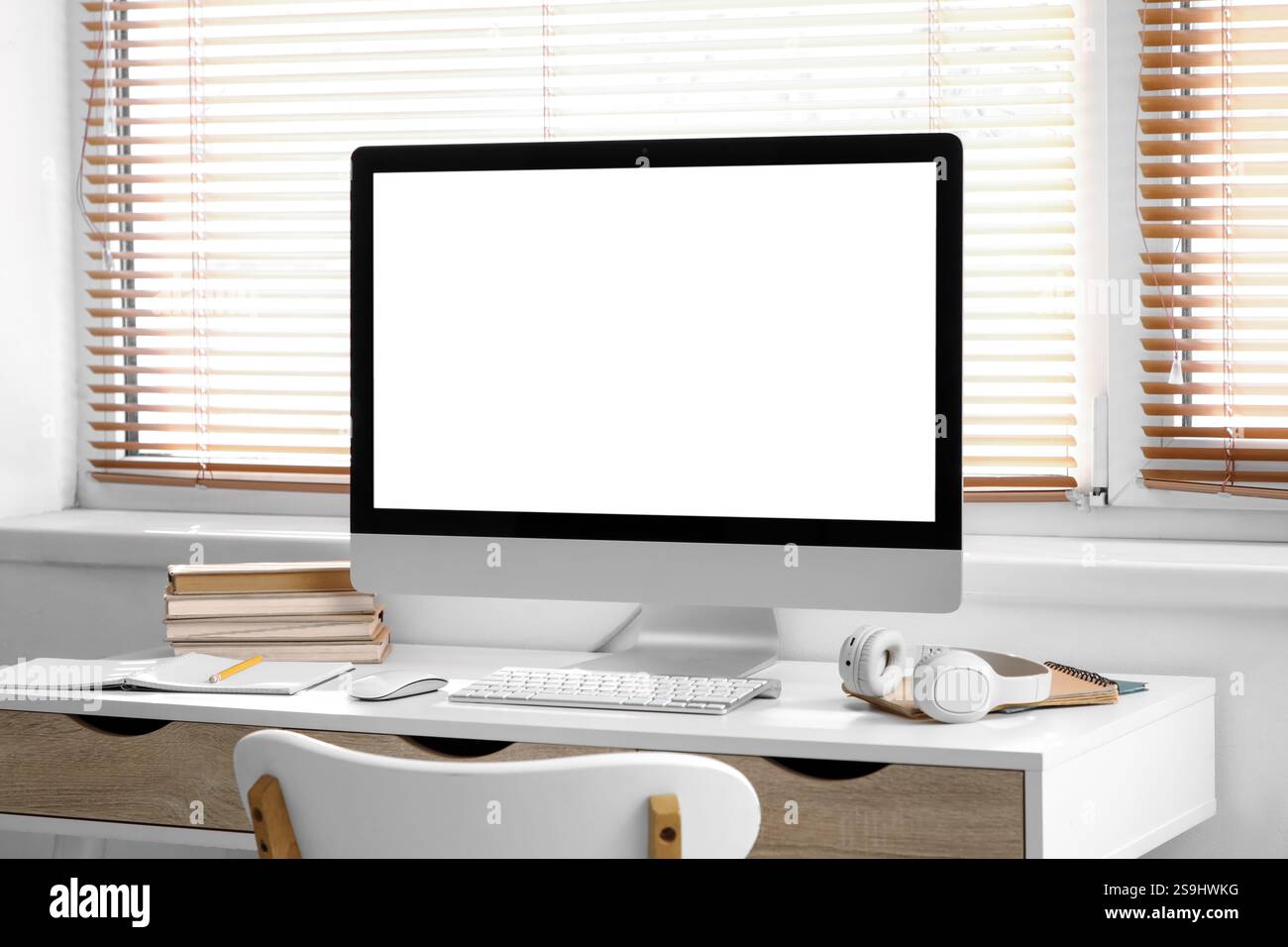 Workplace with blank computer monitor near window in light room Stock ...