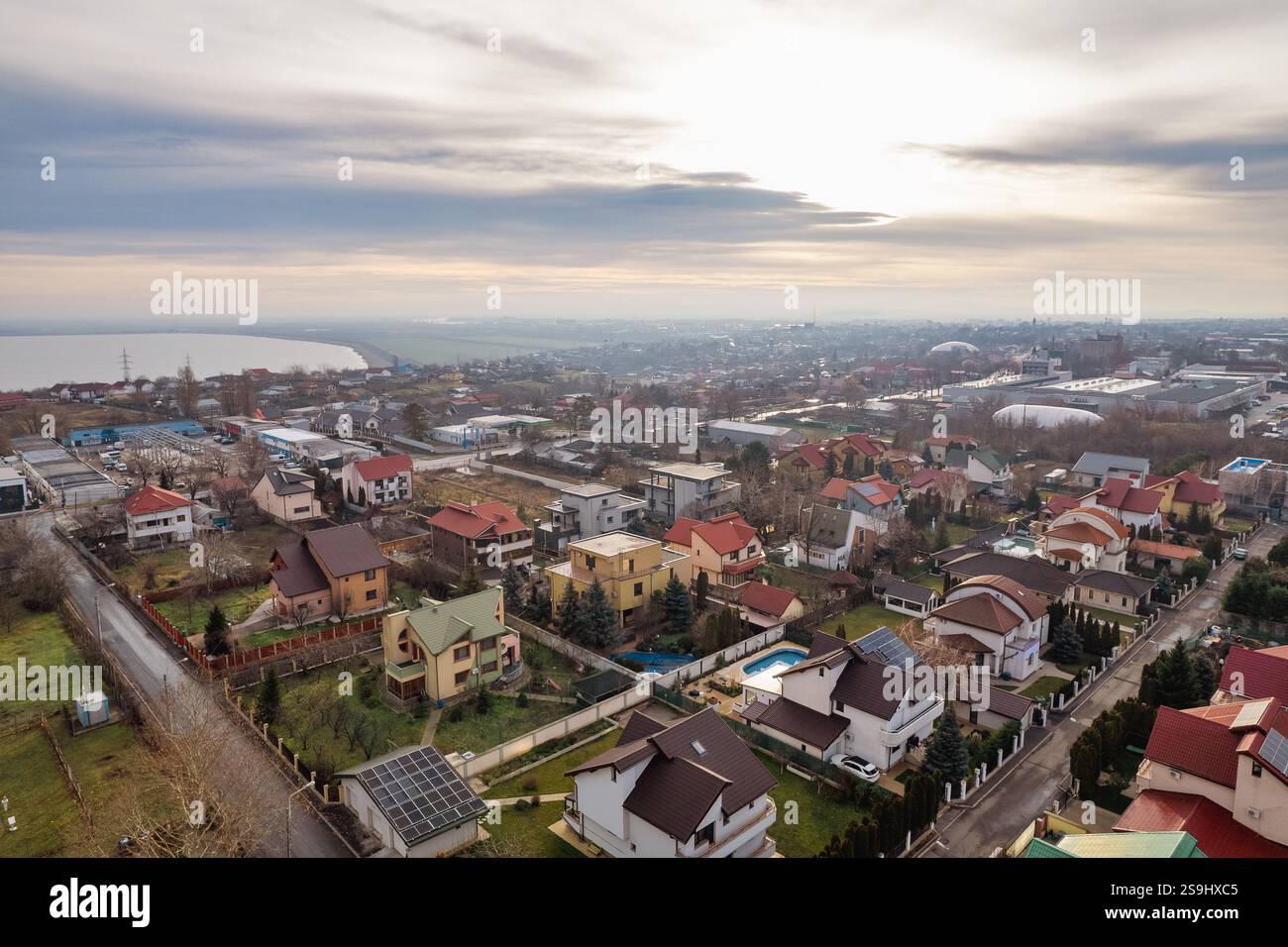 Drone aerial view over morning cityscape with the Lake Brates visible ...