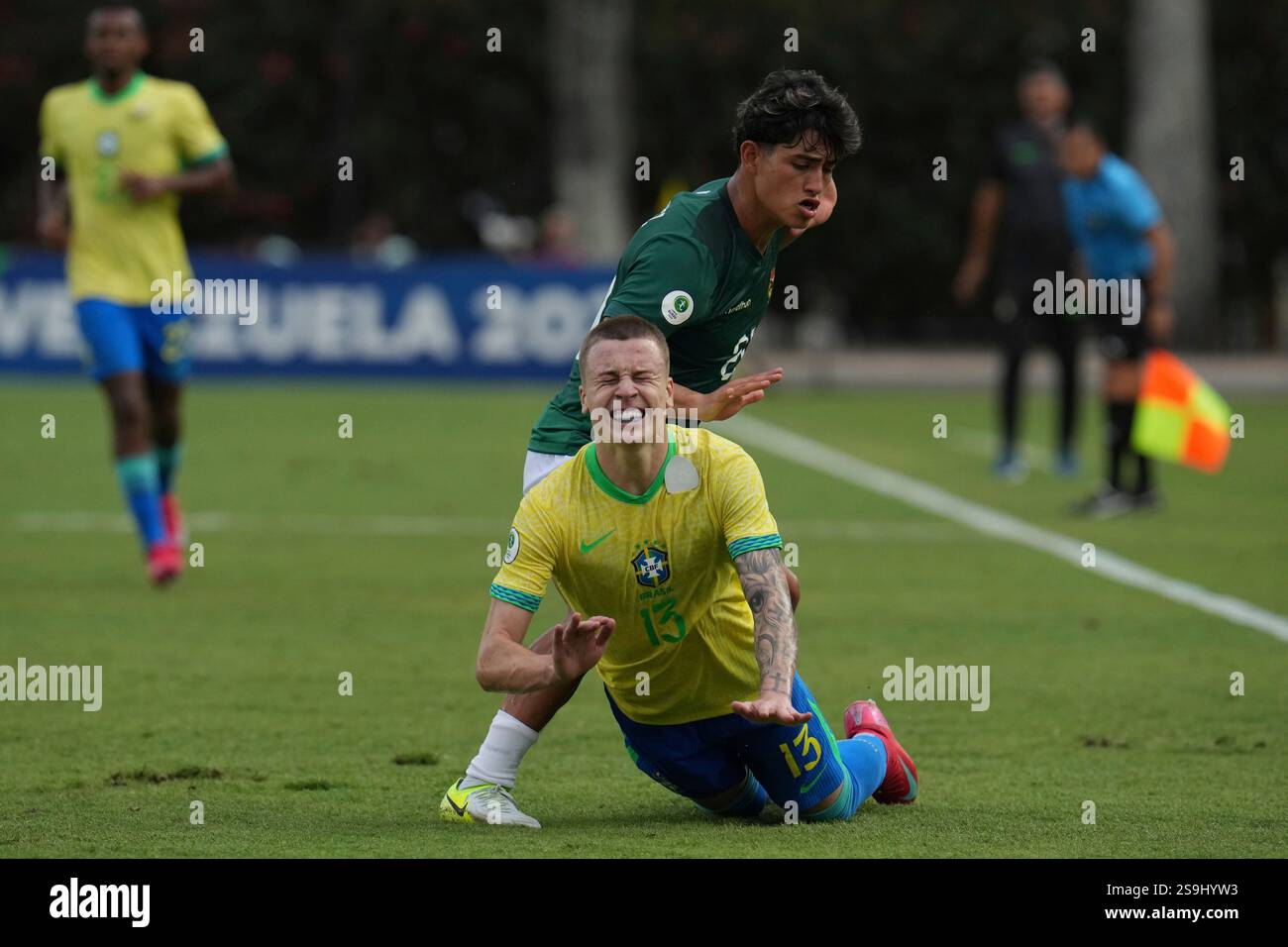 Brazil's Igor Schlemper falls over in front of Bolivia's Mark Rodriguez ...