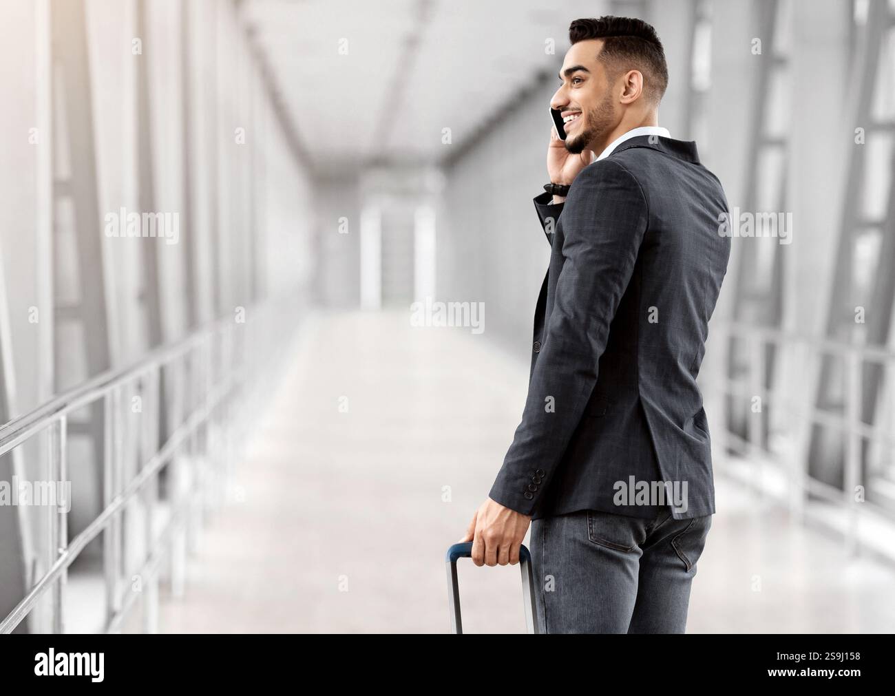 After Arrival. Smiling Arab Businessman Talking On Cellphone While ...