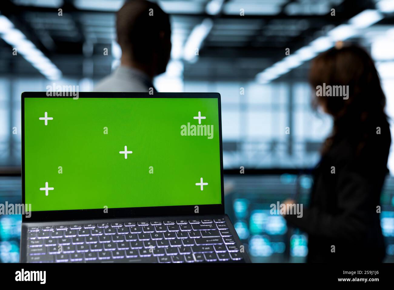 Focus on green screen laptop used by computer scientists in data center inspecting servers ...