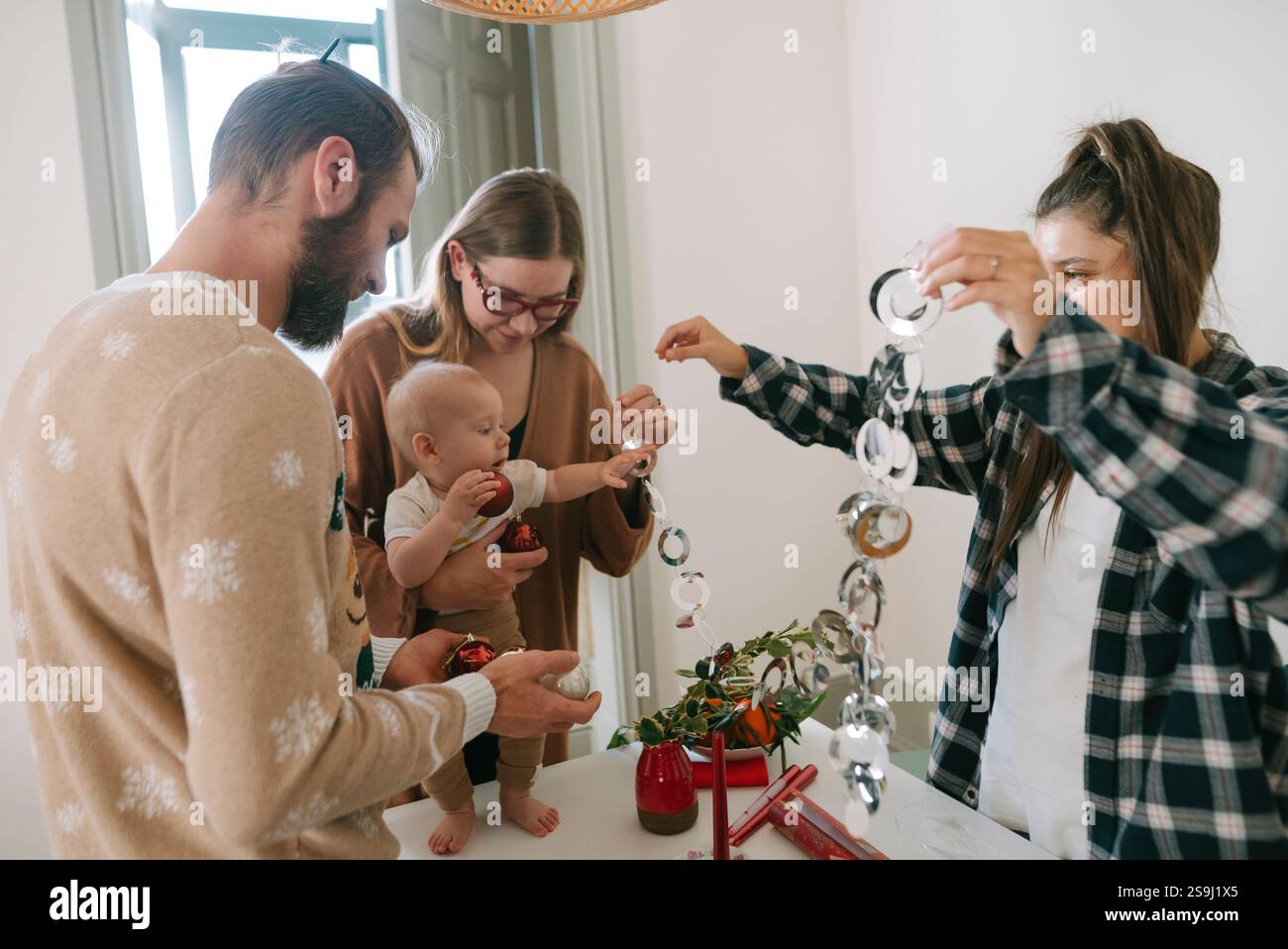 Family members joyfully celebrating together indoors, surrounded by ...