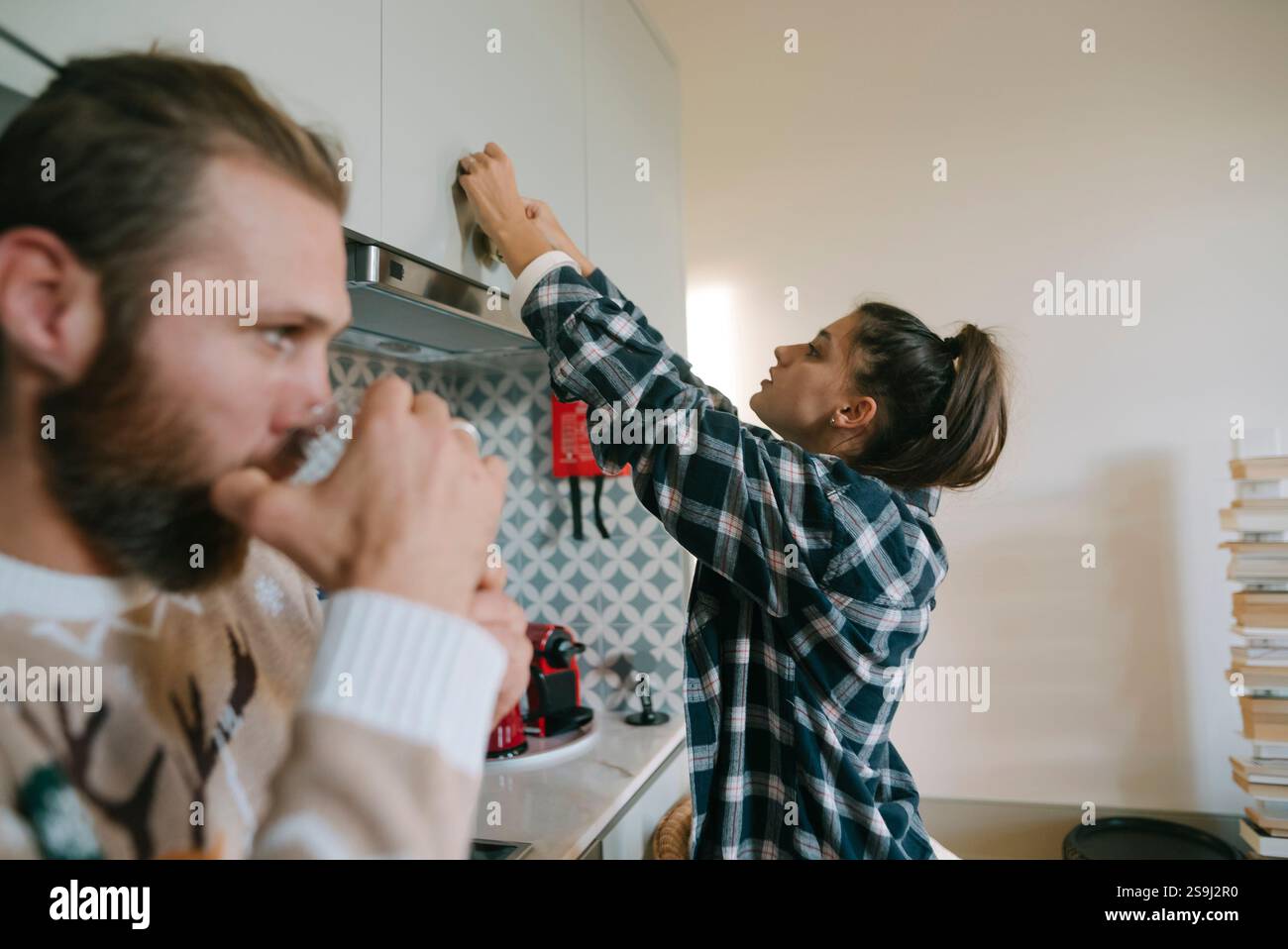 A couple fully engaged in various home repair tasks, followed by ...