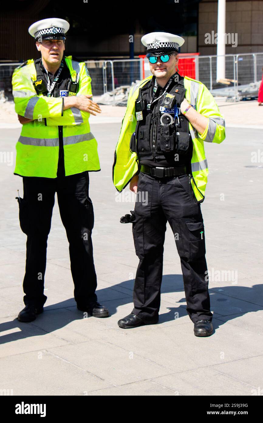 two uk west midlands police officers standing guard in birmingham city ...