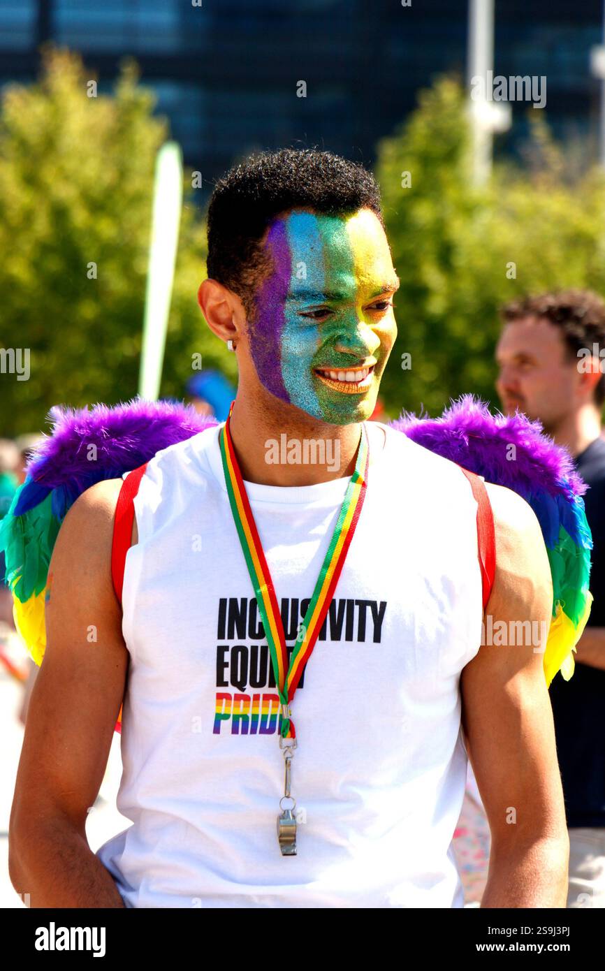 attractive light skinned young black man with painted rainbow face at ...