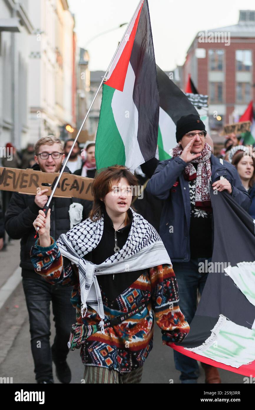 Pro-Palestinian protesters march with flags and placards while chanting ...