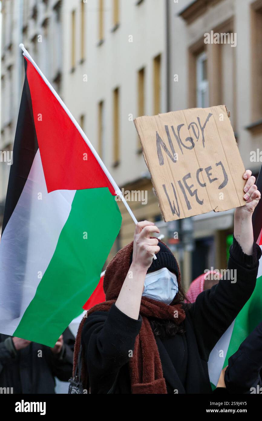 A Pro-Palestinian protester holds a Palestinian flag and a placard ...