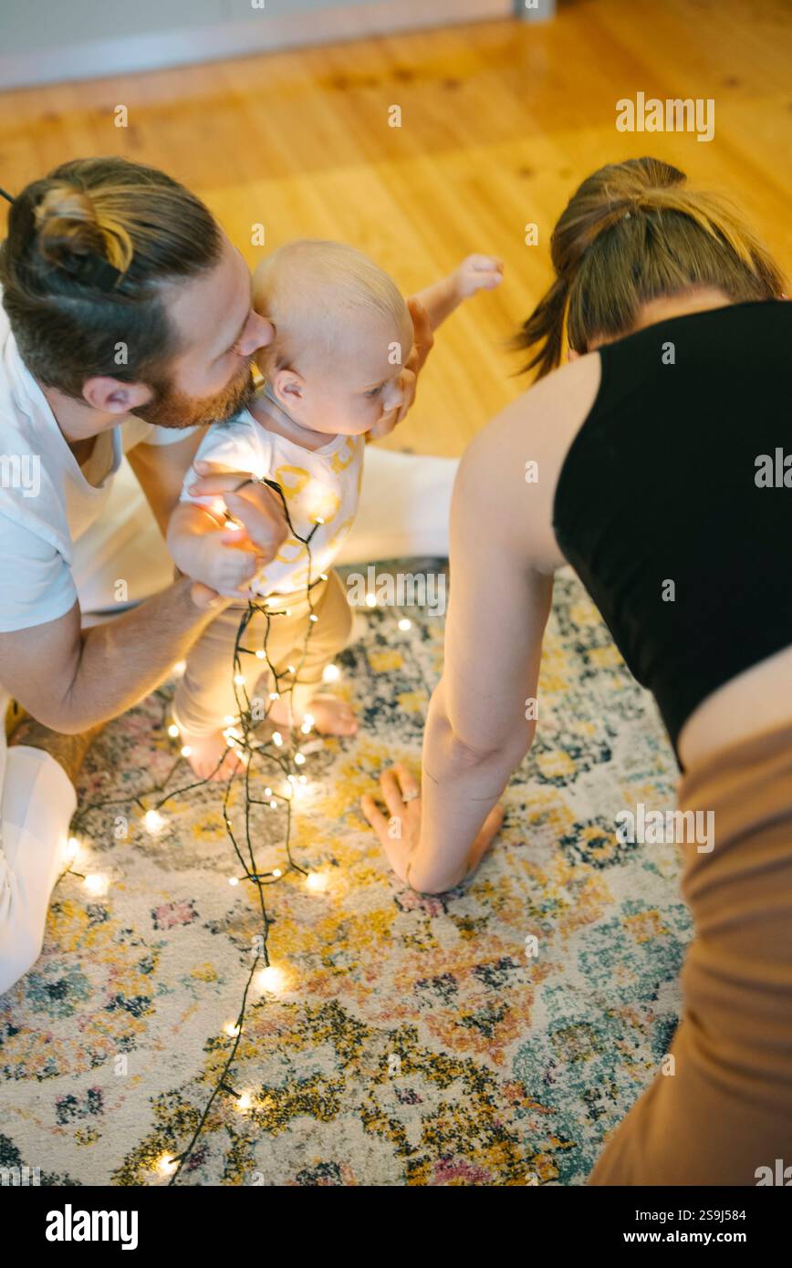 Family Happiness Engaging Playtime with Baby Amidst Colorful Lights on ...