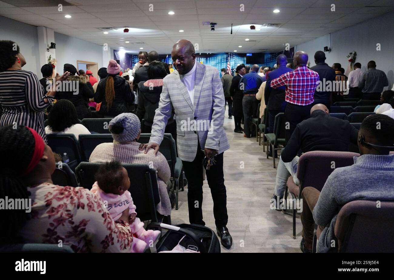 Rev. Reginald Silencieux greets congregants during a service at the ...