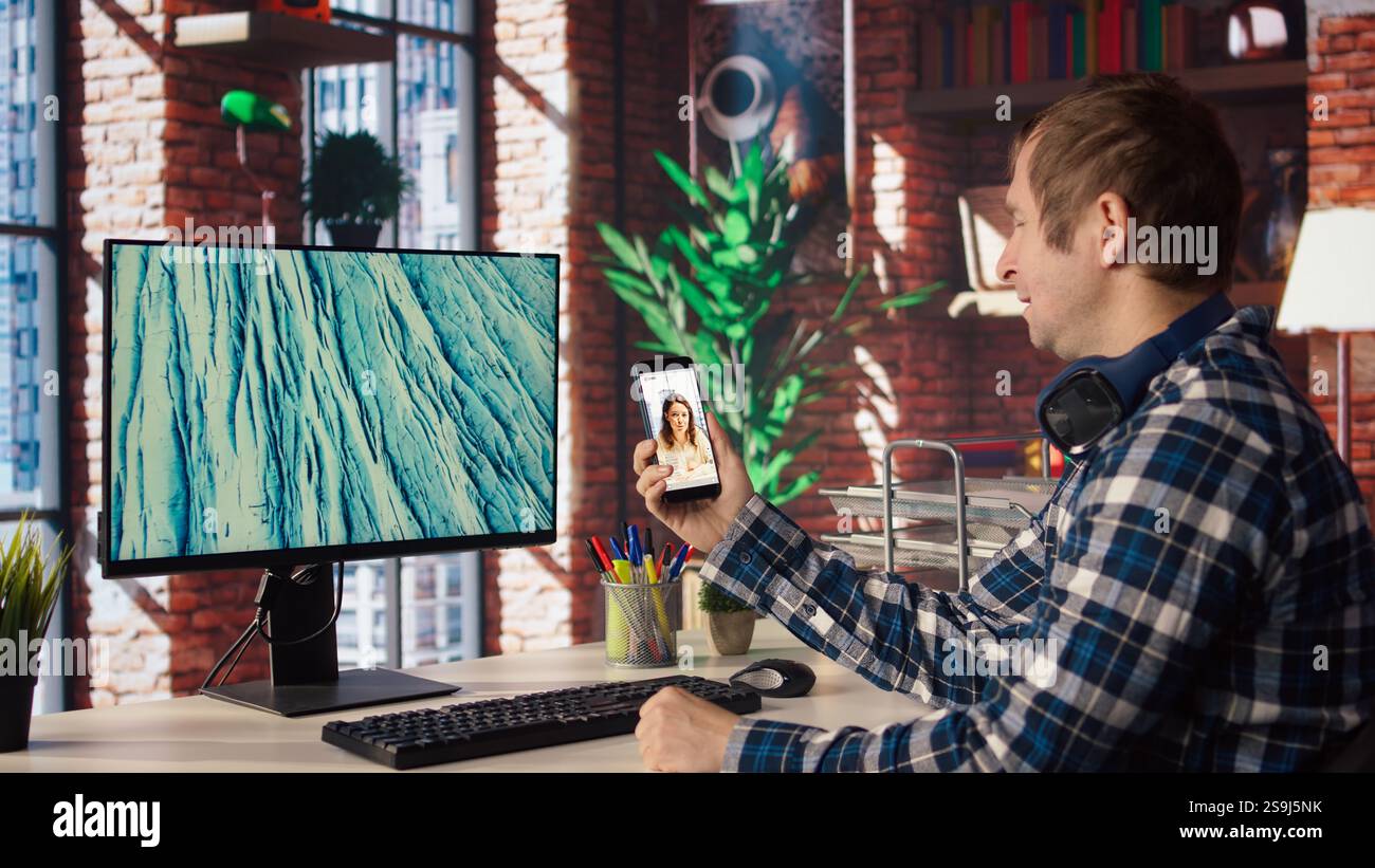 Man in home office looking at social media feed with live broadcasts ...