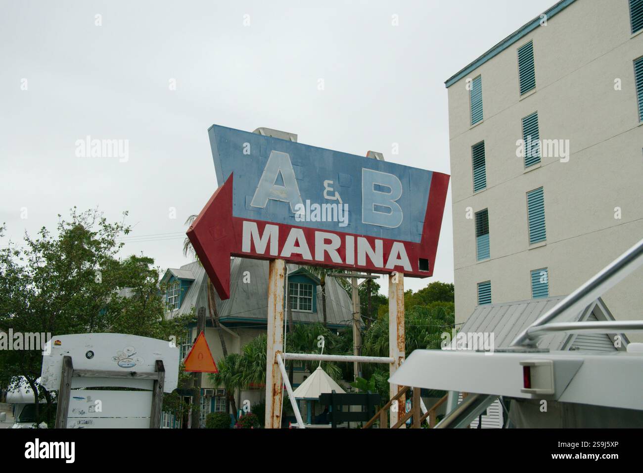 Red and blue sign with a red arrow to the left for A & B Marina Located ...
