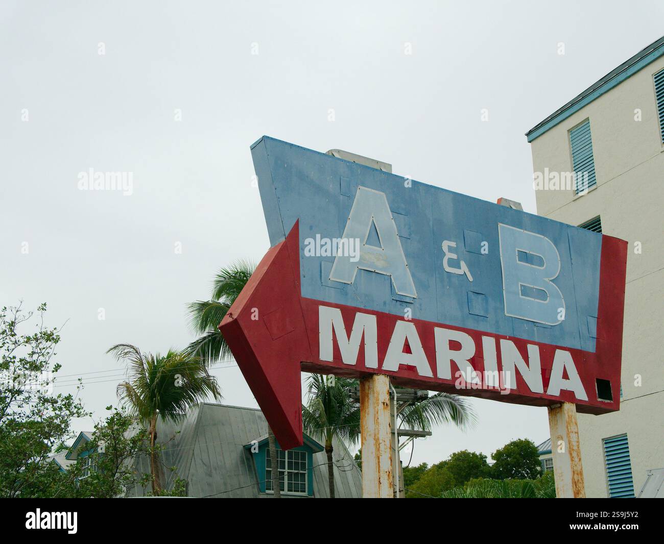 Red and blue sign with a red arrow to the left for A & B Marina Located ...