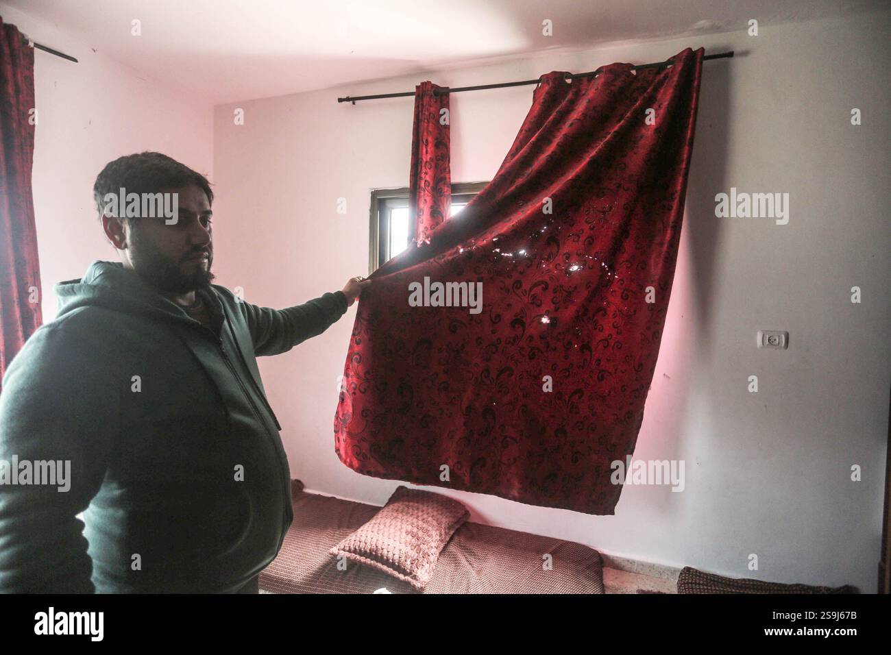 A bullet-riddled window is seen in a room of two-and-a-half-year-old ...