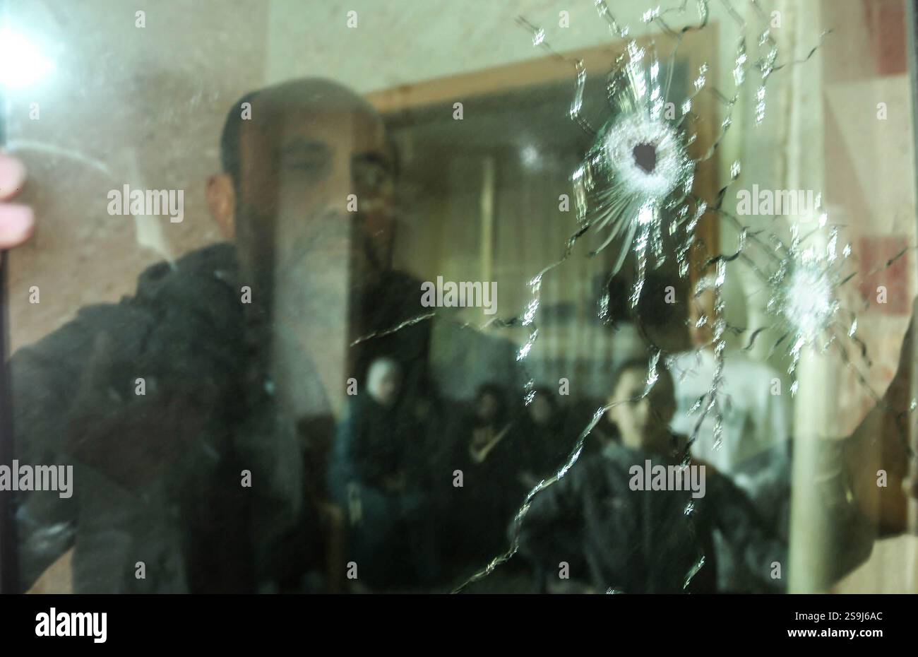 A bullet-riddled window is seen in a room of two-and-a-half-year-old ...