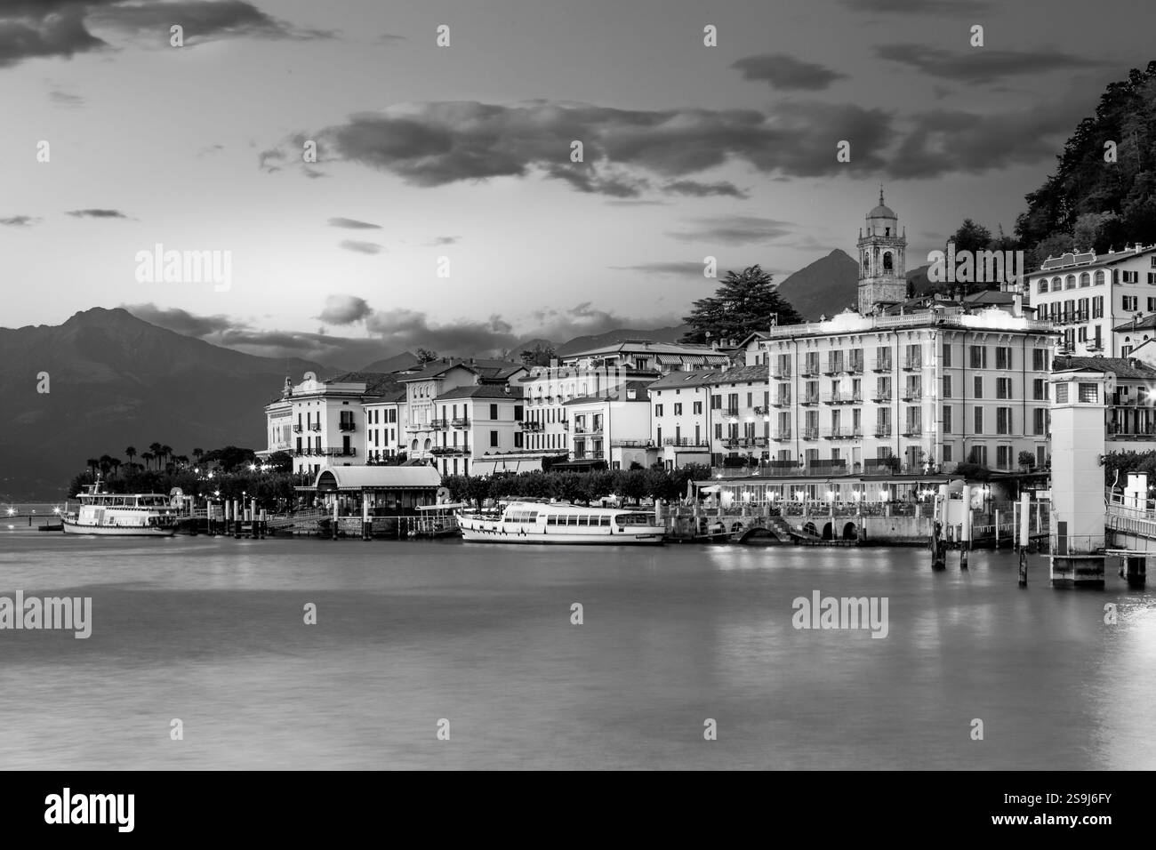Lake Como reflecting Bellagio village at sunset with dramatic sky and ...