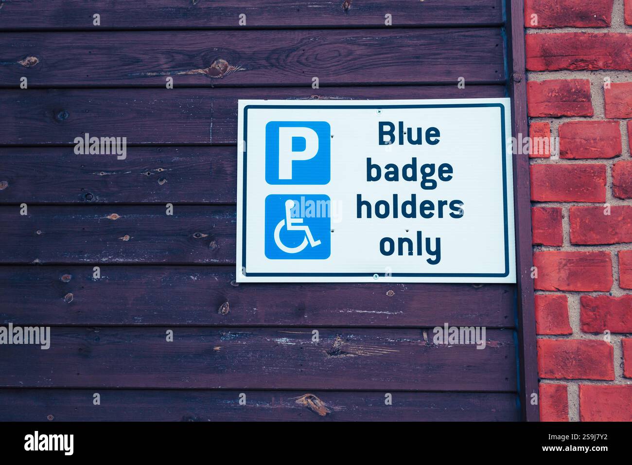 Signage on a wall that parking is for Blue badge holders a designated ...