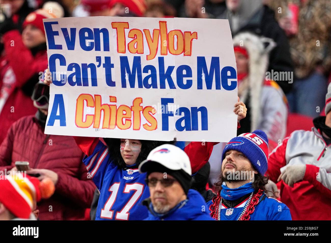 A fan holds a sign before the AFC Championship NFL football game ...