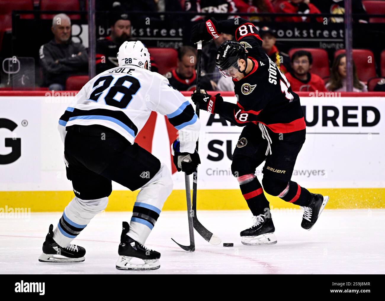 Ottawa Senators' Tim Stutzle (18) tries to get the puck past Utah ...