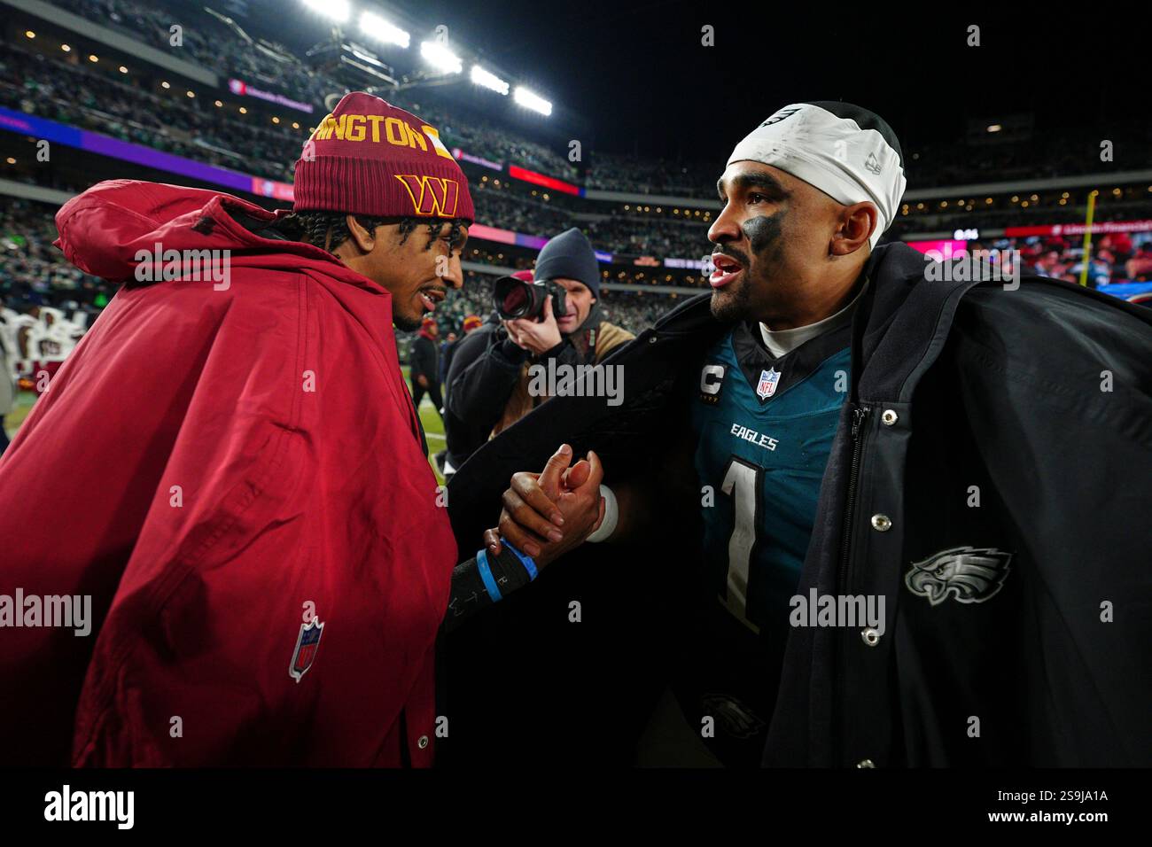 Washington Commanders quarterback Jayden Daniels, left, and ...