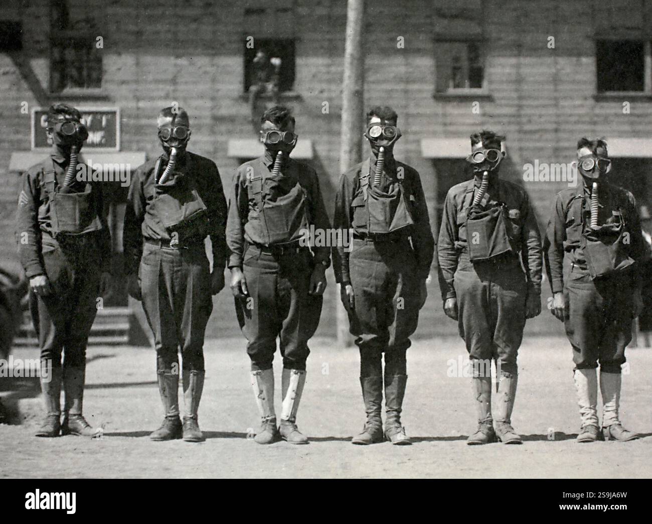 U.S. Army soldiers line up wearing gas masks at training camp during ...
