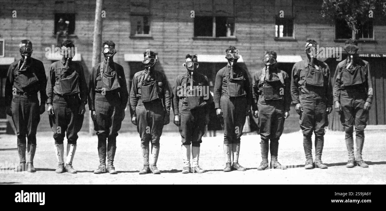 U.S. Army soldiers line up wearing gas masks at training camp during ...