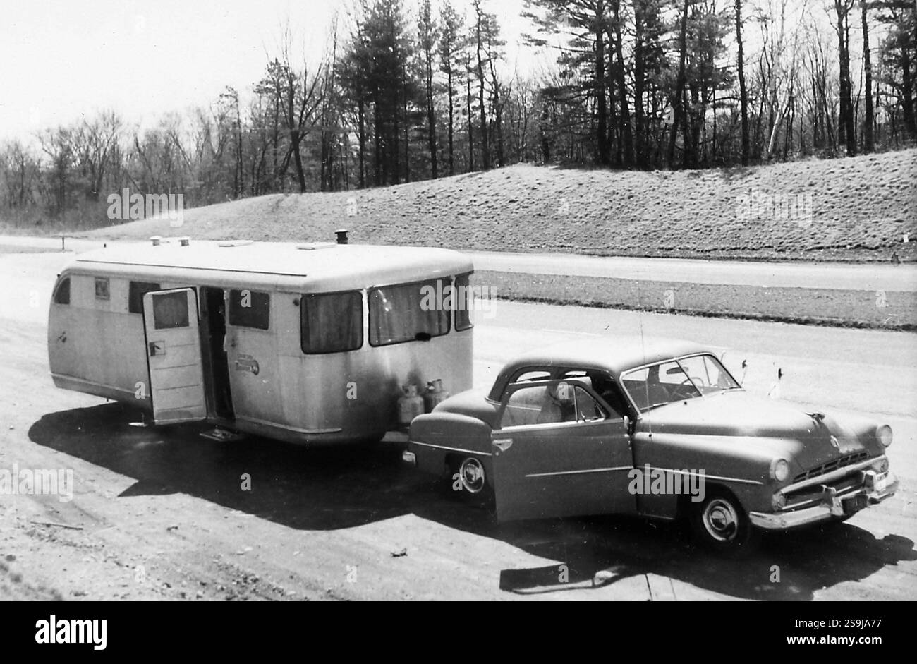 A car pulling a mobile home is shown alongside the road, ca. 1954 Stock ...