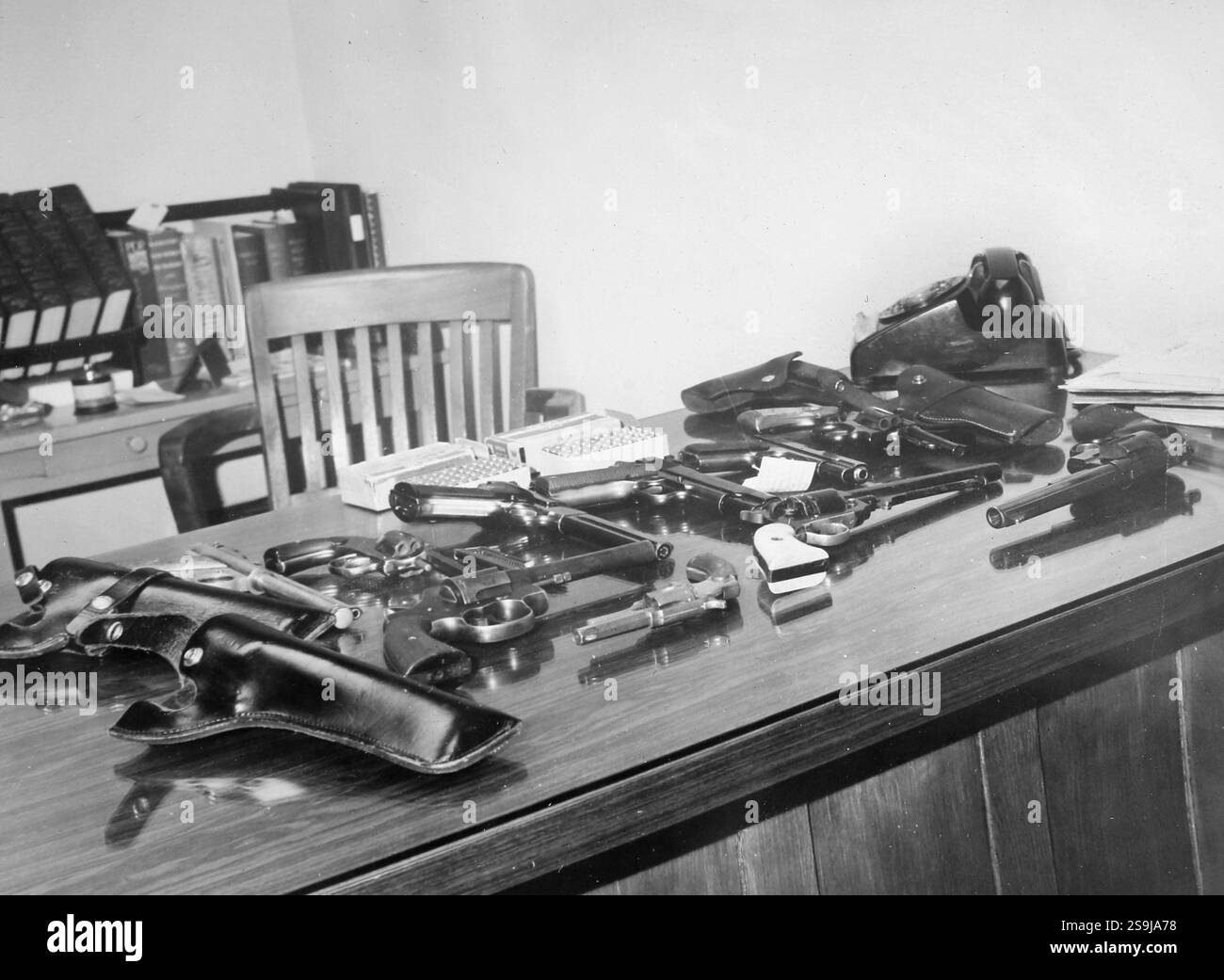 Confiscated illegal guns are shown on a Chicago Police Department desk ...
