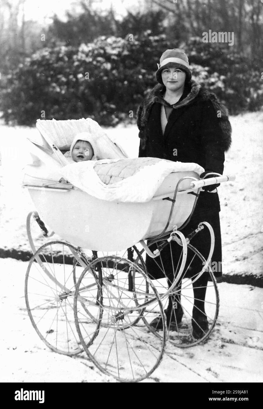 A nanny with baby in a high wheel stroller, ca. 1920 Stock Photo - Alamy
