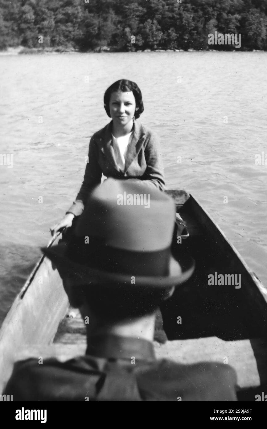 A woman on a row boat date stares back at her date, ca. 1933 Stock ...