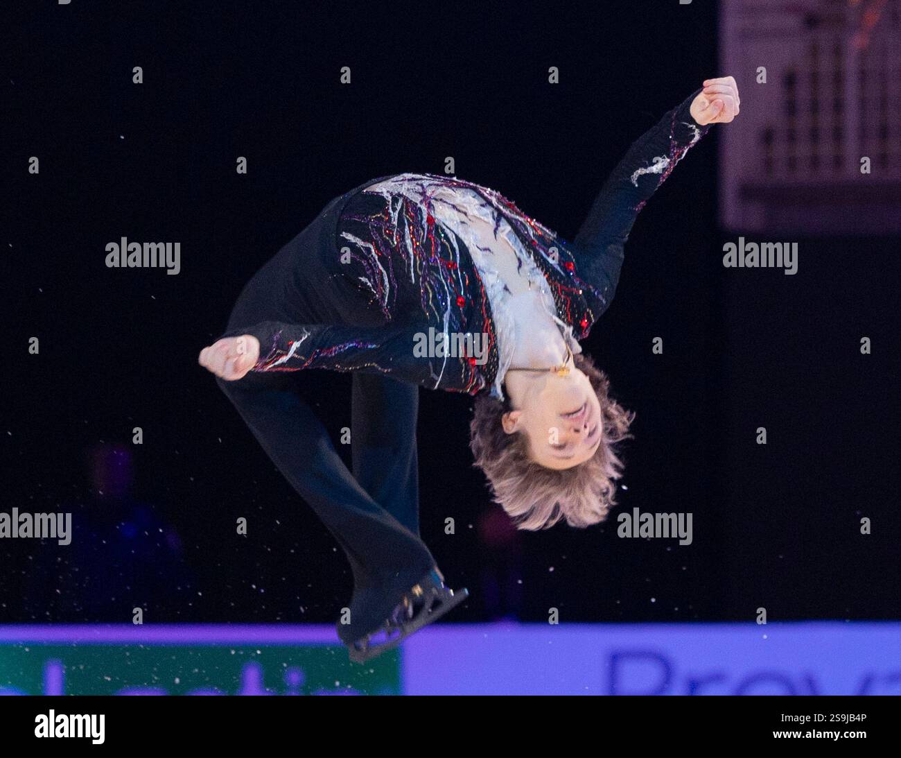 Ilia Malinin does a backflip as he enters the rink for the medal ...