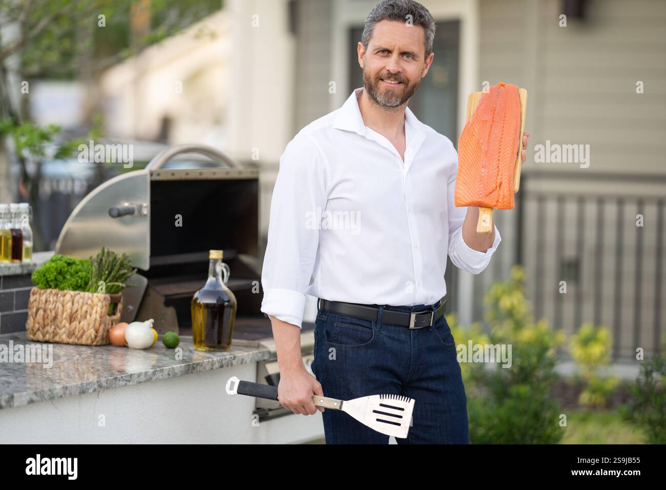 Grill cook. Chef with BBQ cooking tools. Barbecue and grill. Picnic and ...