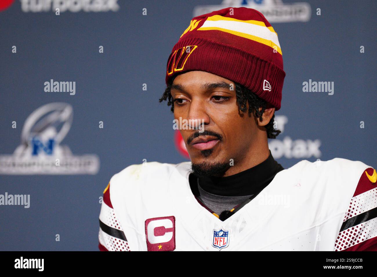 Washington Commanders quarterback Jayden Daniels listens to a question ...