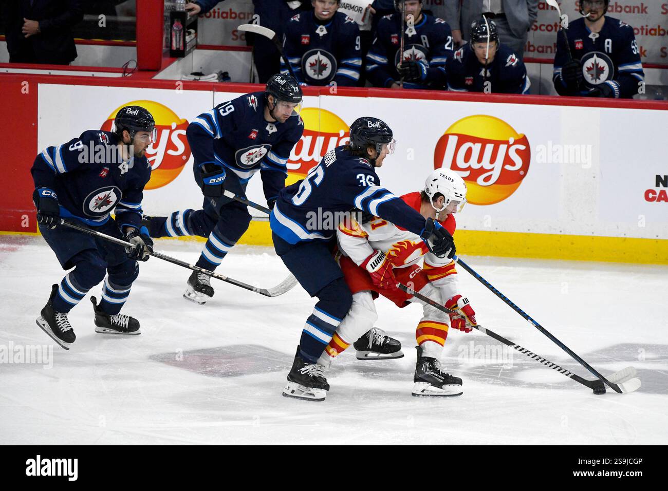 Calgary Flames' Kevin Rooney (21) is wrapped up by Winnipeg Jets ...