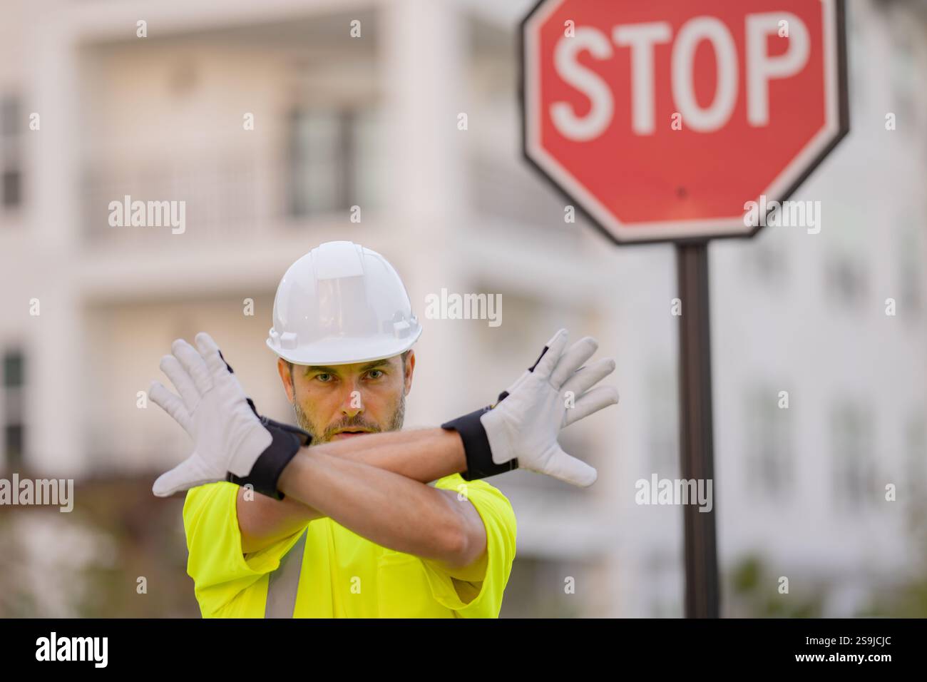 Builder with stop gesture, no hand, dangerous on building concept. Man ...
