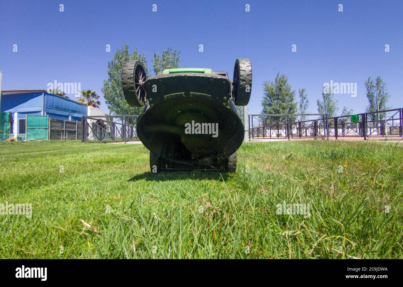 Lawn mower blade spinning. Blades of grass flying in the air Stock ...