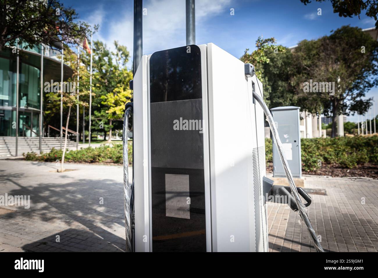 electric car (EV charging station) charger stands outside a public ...