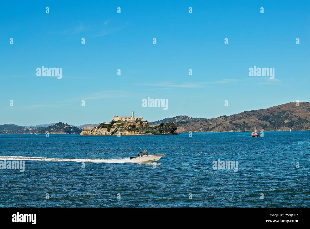 Alcatraz Island in San Francisco Bay with passing speed boat Stock ...