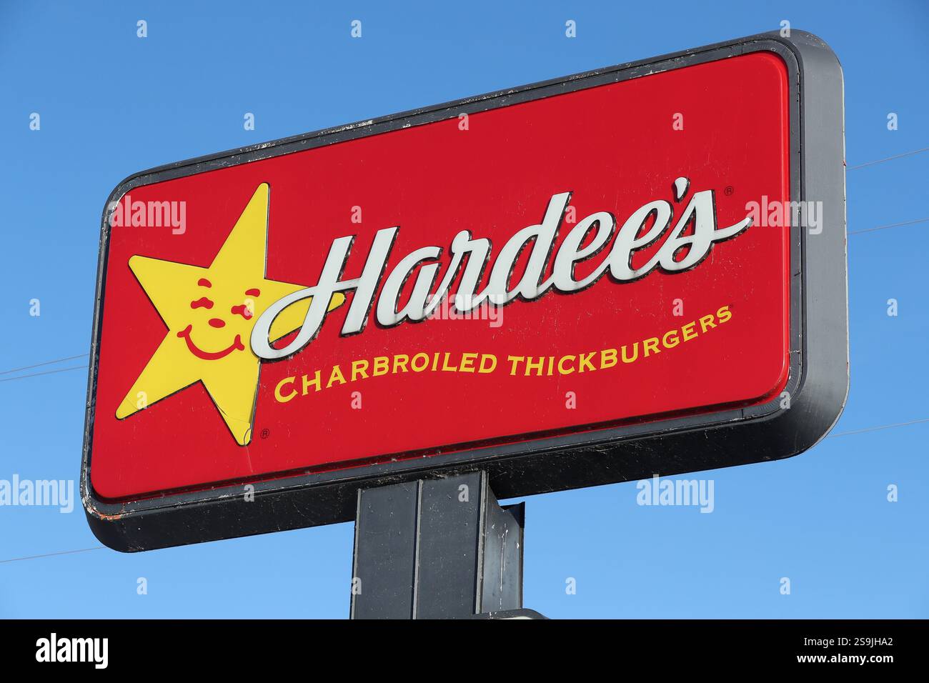The Hardee's logo is seen on a sign outside of the fast food restaurant ...