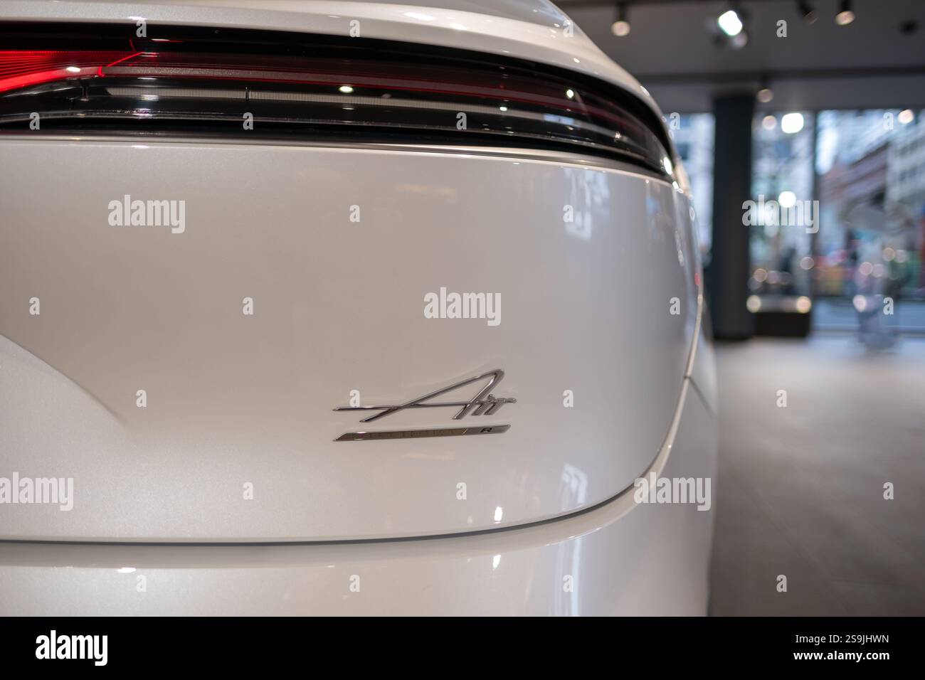 close-up white Lucid Air's rear quarter panel, "Air" badge, battery ...