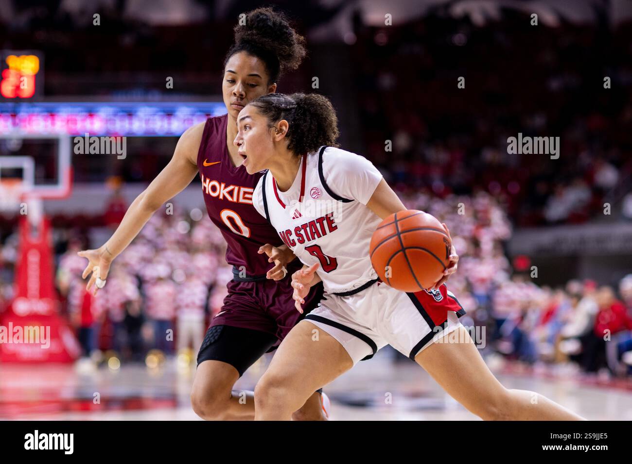 January 26, 2025: NC State guard Devyn Quigley (0) drives on Virginia ...