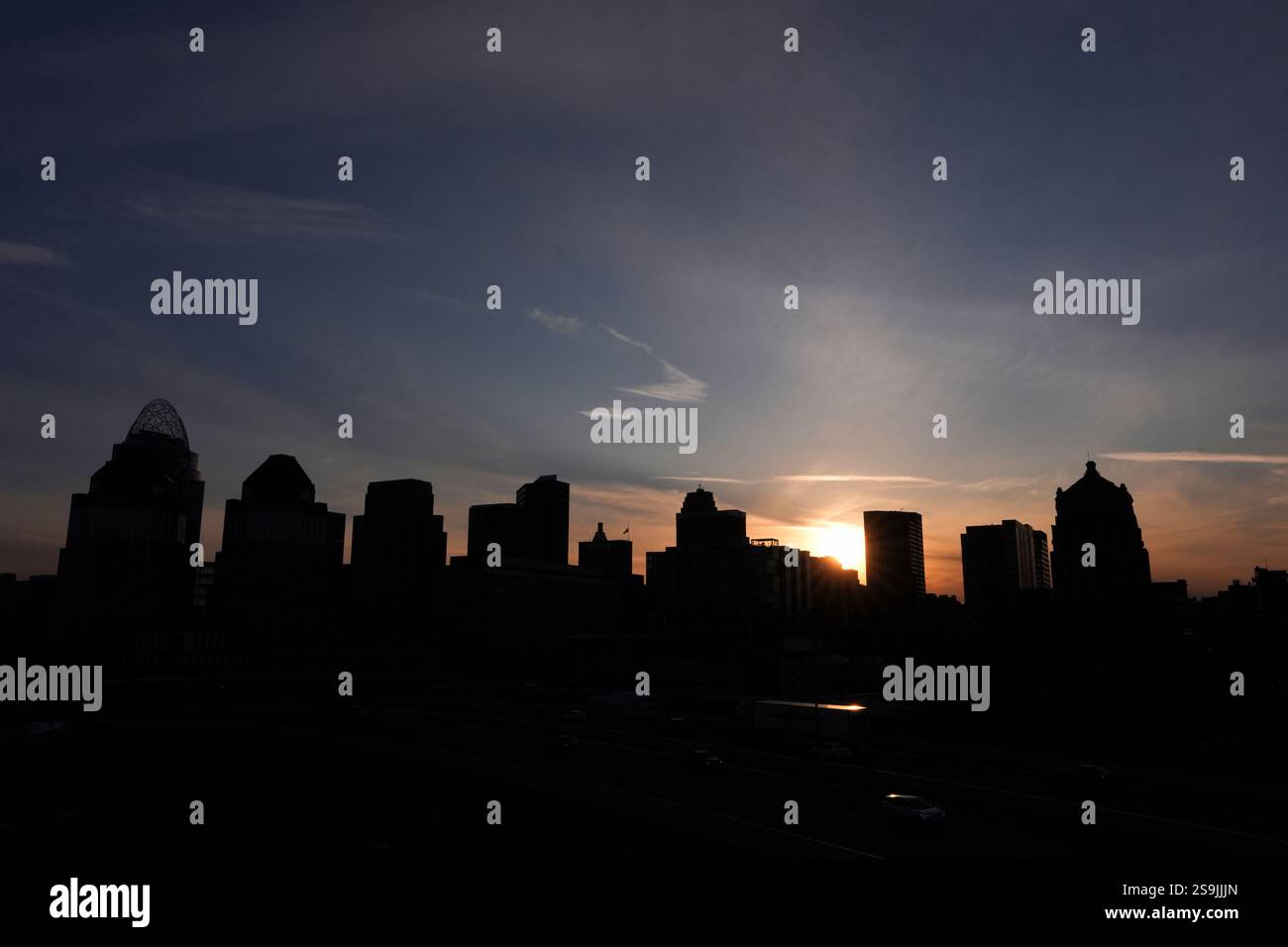 The downtown Cincinnati skyline is silhouetted during sun set, Sunday ...