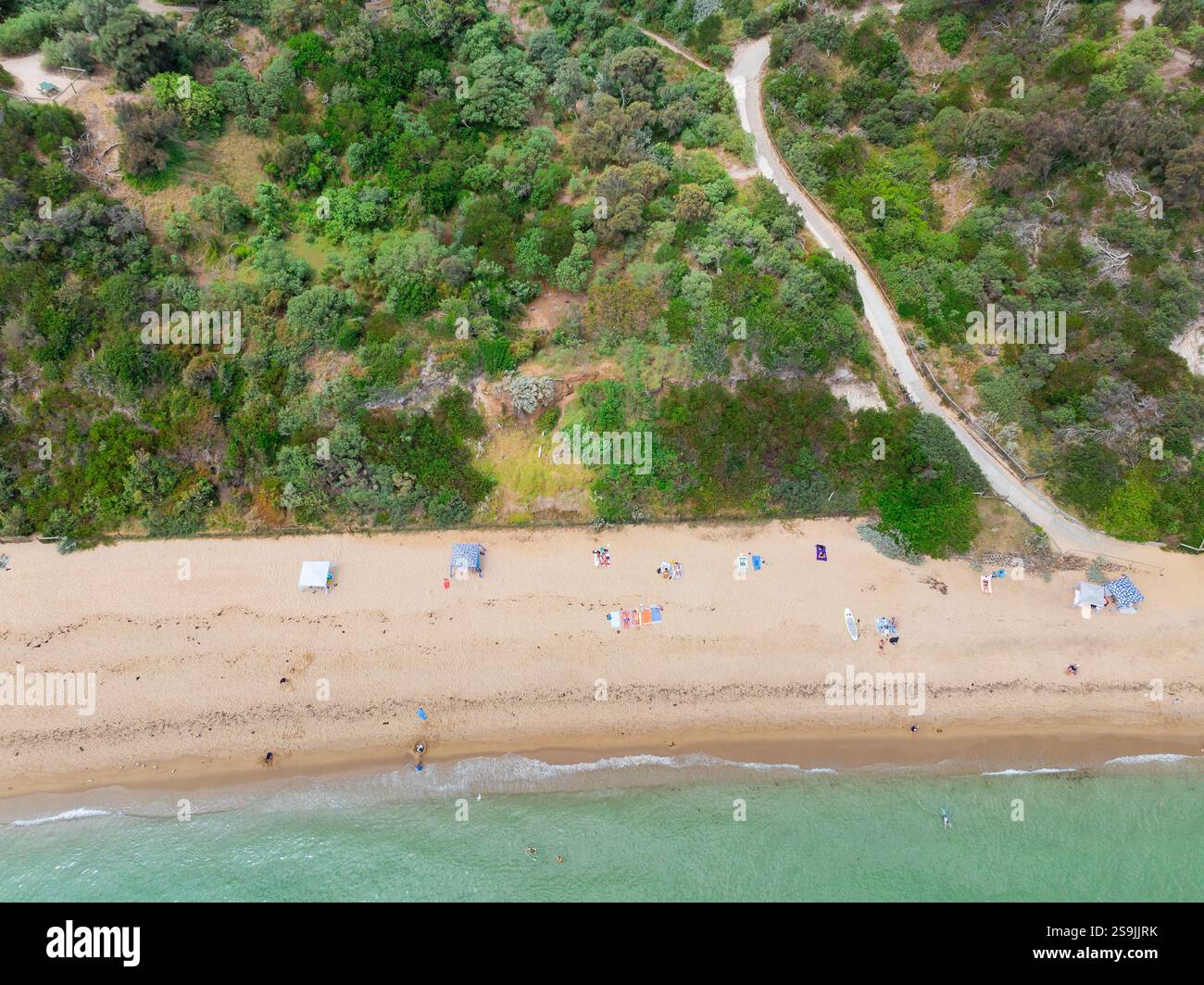 Aerial view of shelters on a bayside beach below a tall staircase at ...