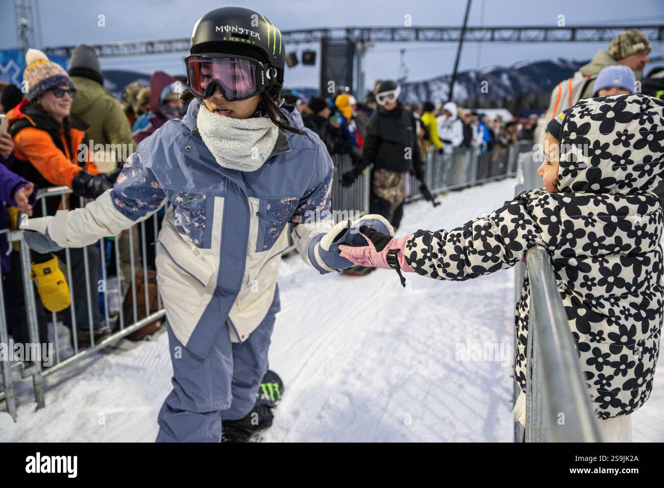 January 25, 2025, Aspen, Colorado, USA: Snowboarder CHLOE KIM highfives ...