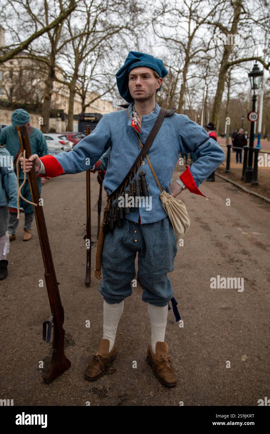 A member of the English Civil War Society wearing a blue uniform and ...