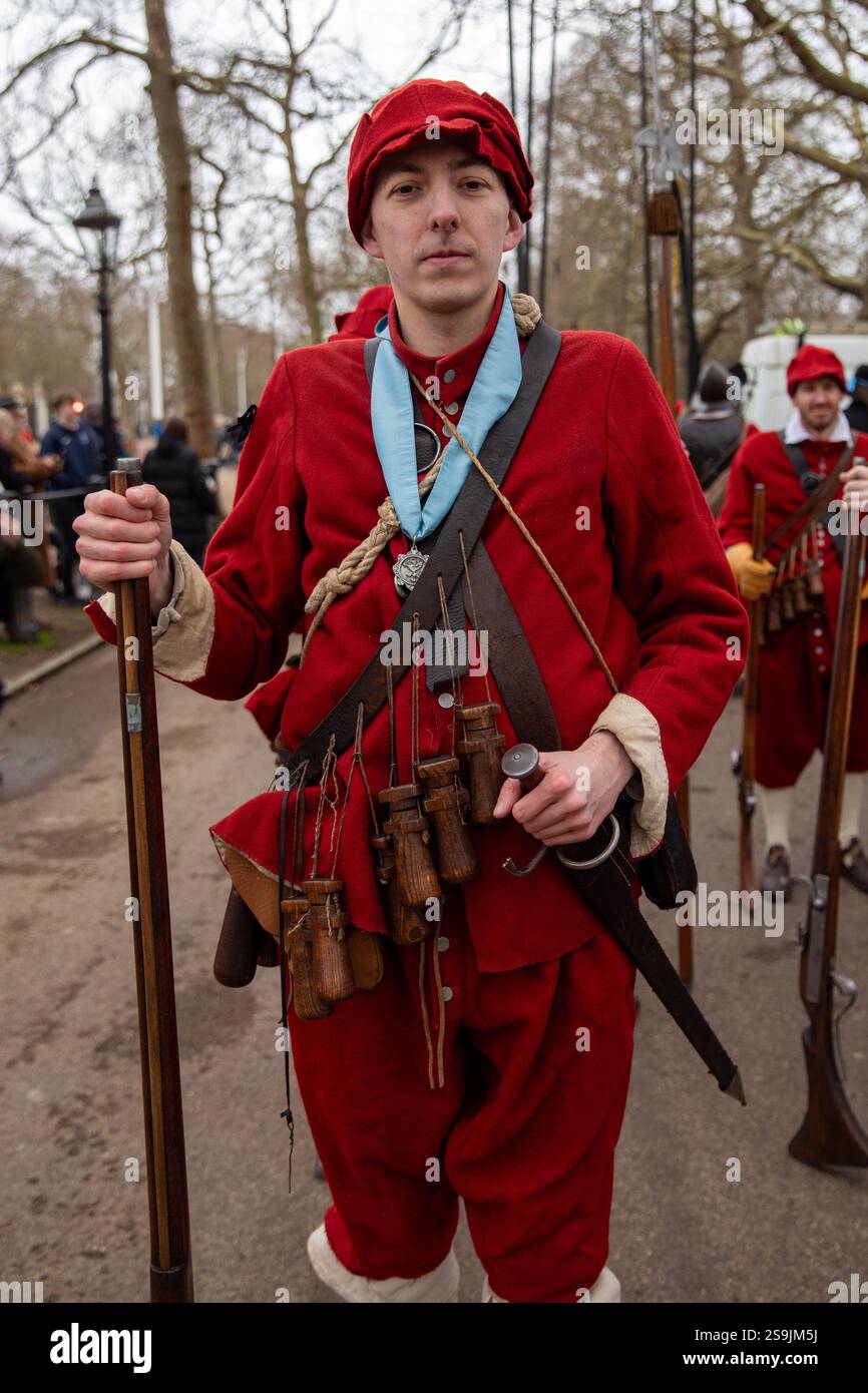 A member of the English Civil War Society wearing a red uniform and ...