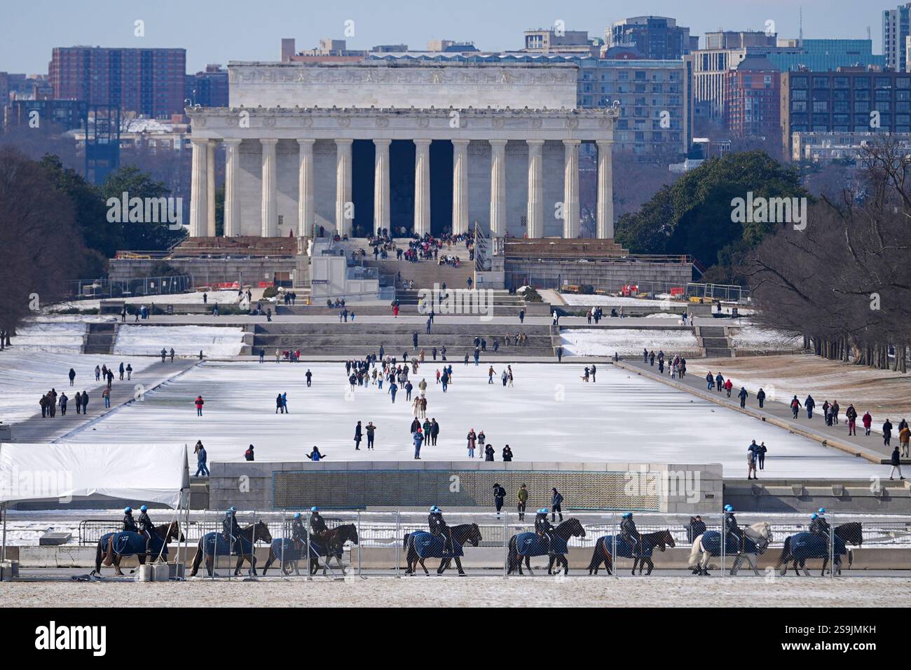 Officials atop horses patrol the National Mall during the 60th ...