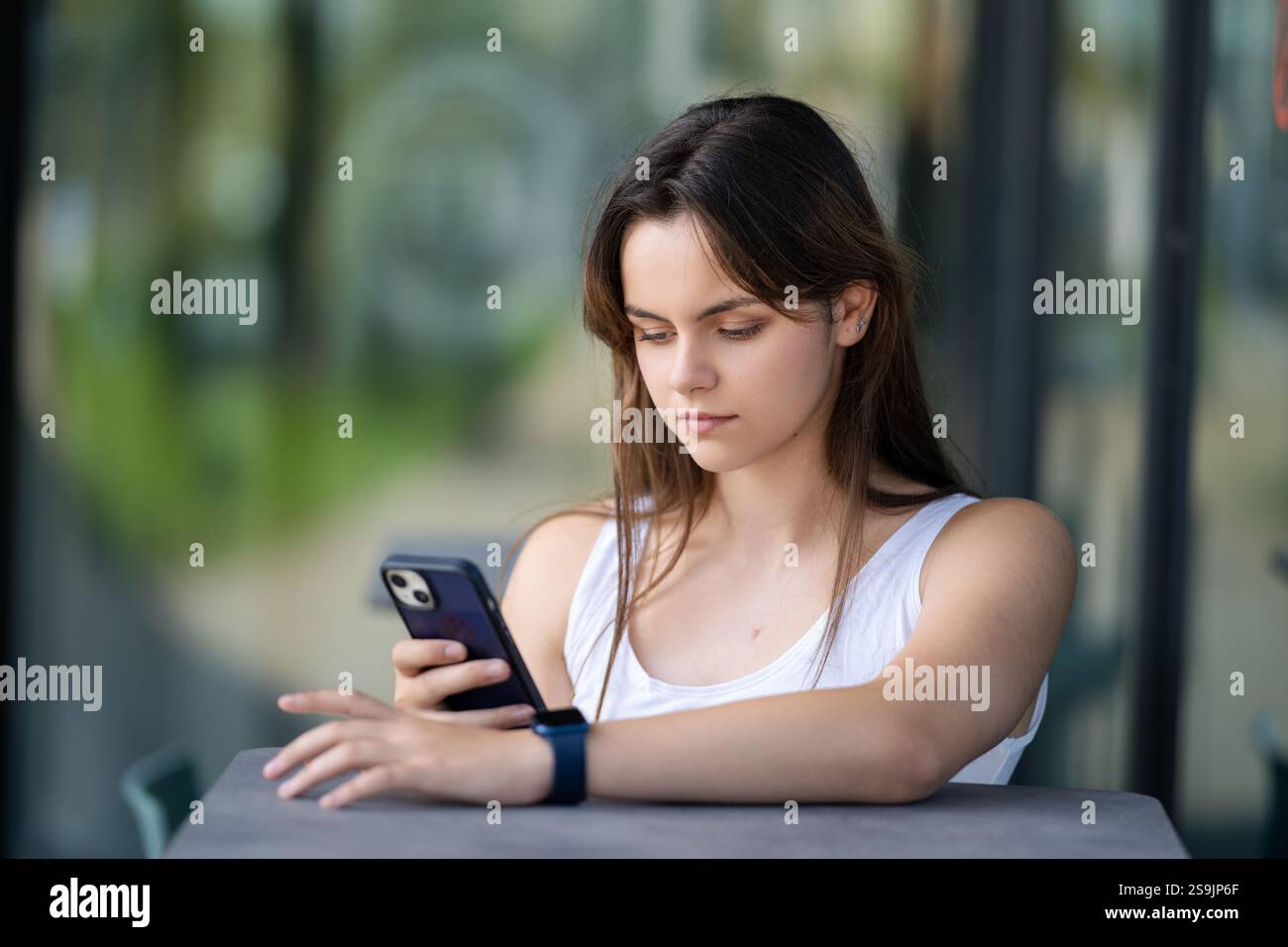 Teen girl checking messages. Teenager talking on phone. Girl using ...