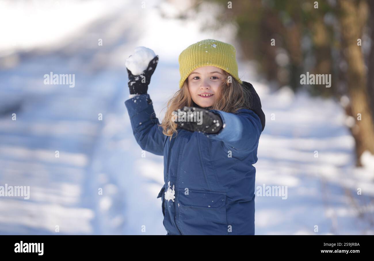 Child play with snow outdoors during first snowfall. Winter activities ...