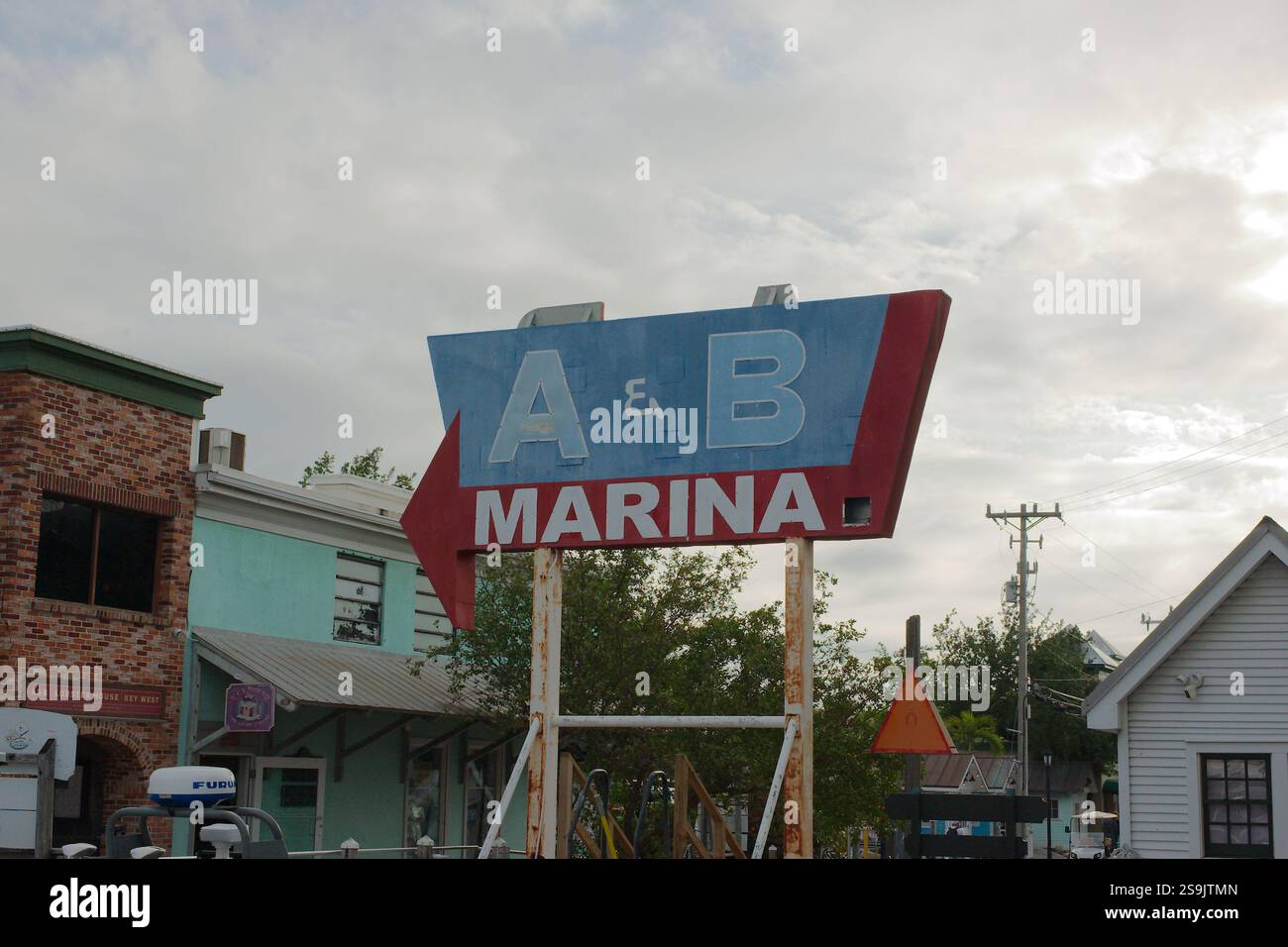 Red and blue sign with a red arrow to the left for A & B Marina Located ...
