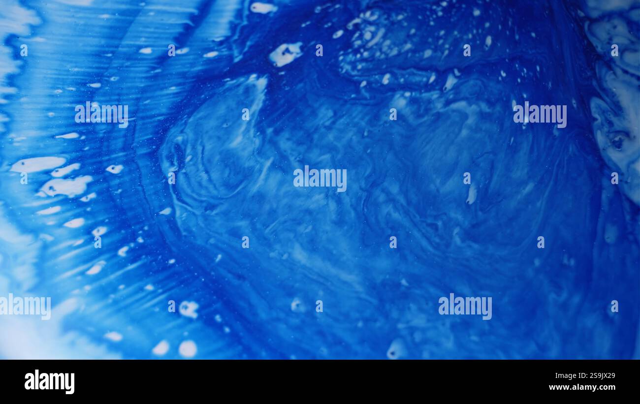 Art fluid. Paint expansion. Bright blue marble liquid spreads over wet ...